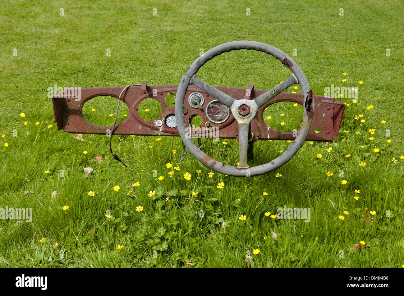 Humorous sculpture of a rusty driving wheel and dashboard, in long ...