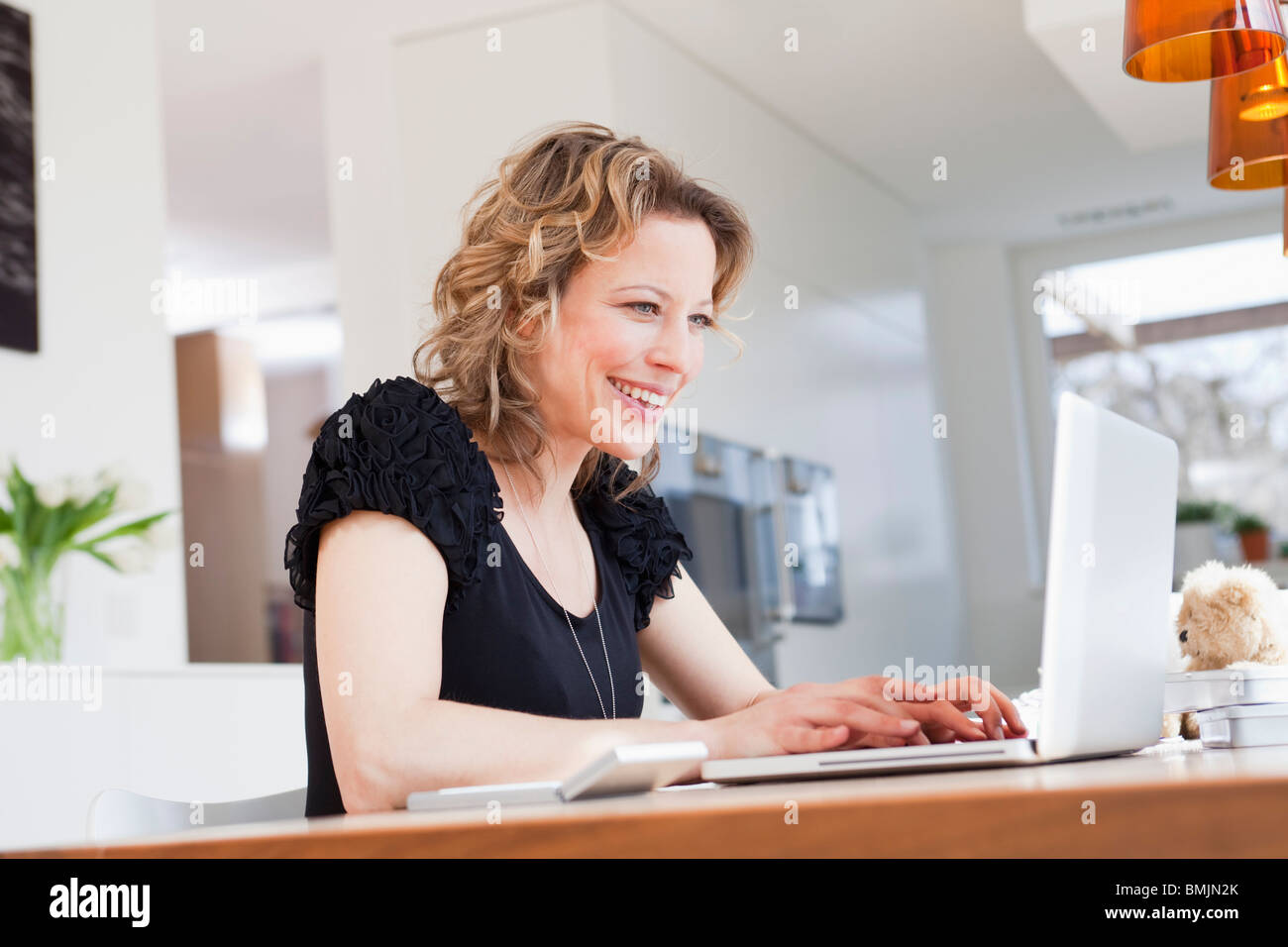 Woman working with laptop Stock Photo - Alamy