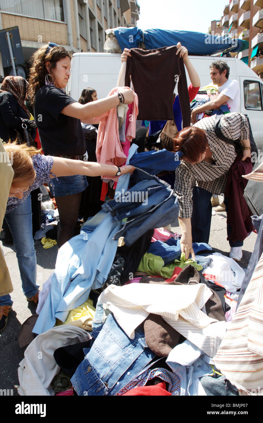 Women Look And Choose A Stock Of Old Used Clothes In Porta Portese Rome women-look-and-choose-a-stock-of-old-used-clothes-in-porta-portese-rome