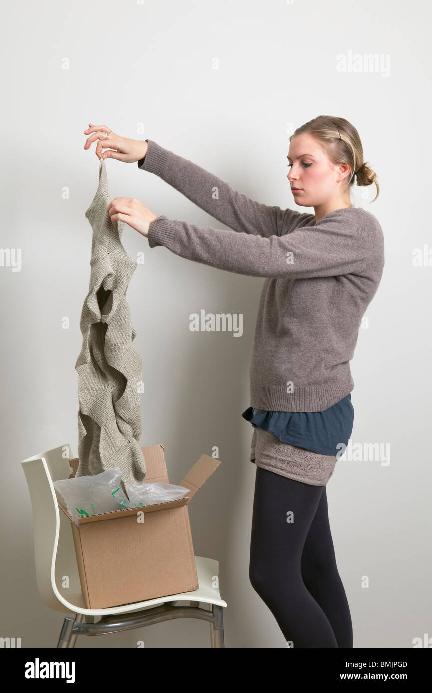 Woman taking scarf out of box Stock Photo - Alamy
