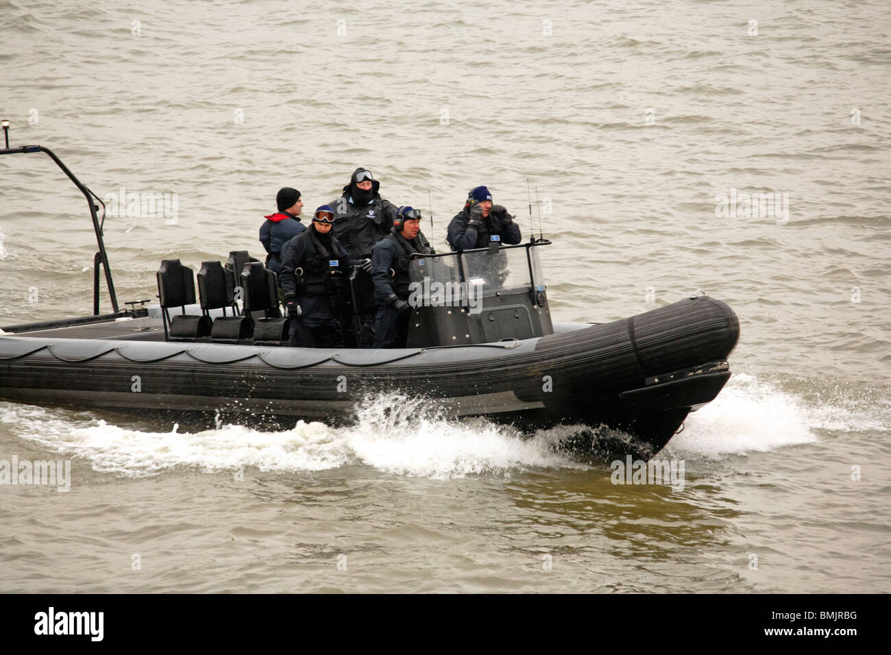 Black clad police in semi-dirigible boat on the river Thames Stock ...