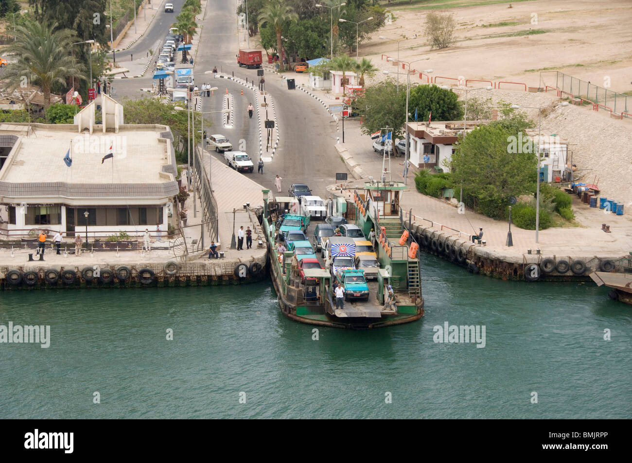 Egypt, Suez Canal. Typical canal views, auto ferry that takes ...