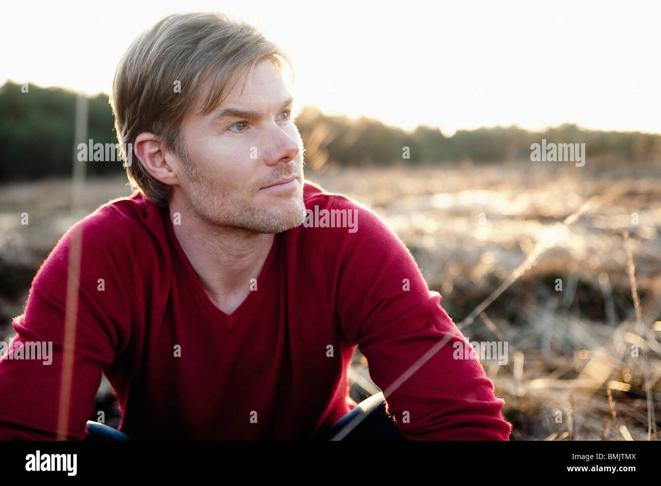 Man in open field during sunset Stock Photo - Alamy