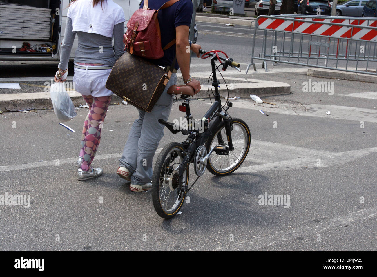 two young walk with a bicycle scene outdoor street Rome Italy Stock ...