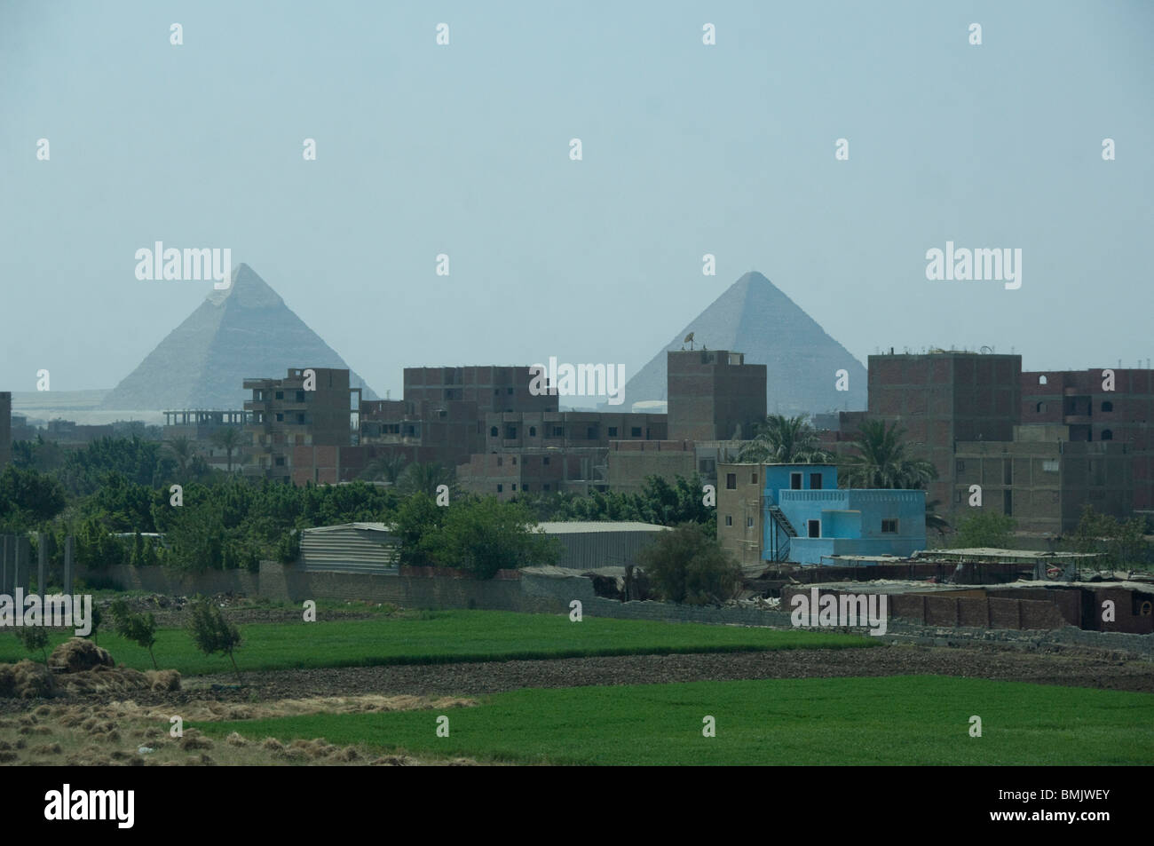 Egypt, Cairo. The Great Pyramids of Giza surrounded by downtown Cairo ...