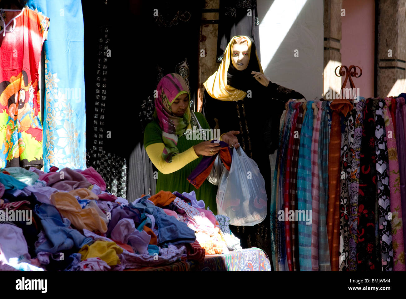 Woman shopping for clothes at the Aswan Souq, Aswan, Egypt Stock Photo - Alamy
