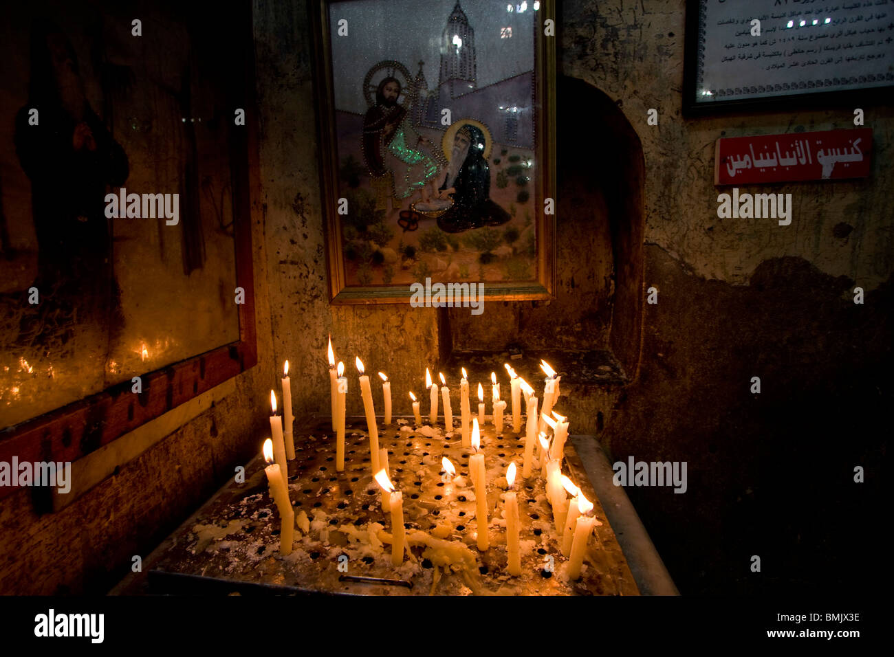 Candles lit in front of an icon in the Church of St. Bishoy in the St ...