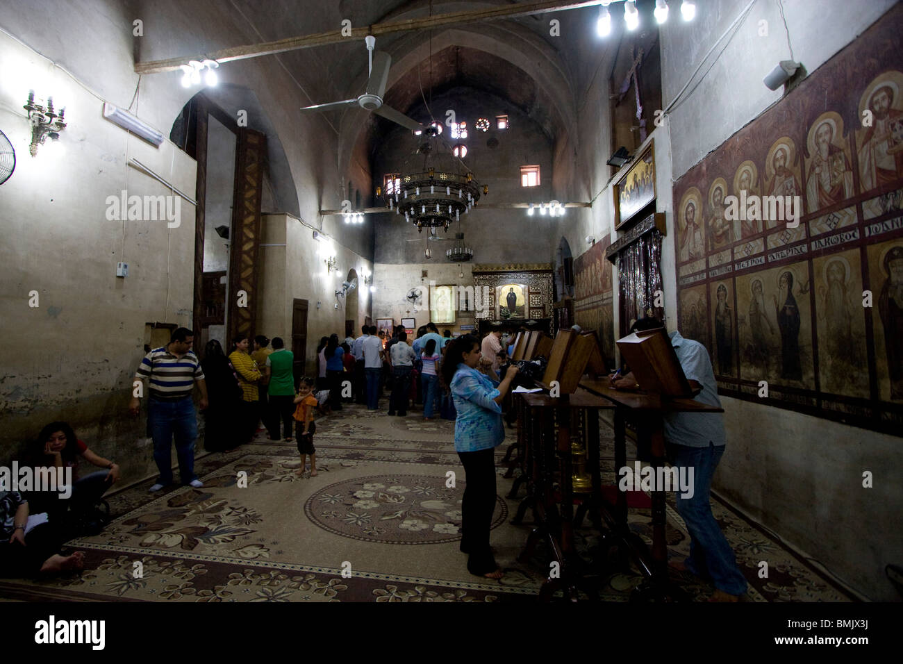 People praying in the Church of St. Bishoy in the St. Bishoy Monastery ...