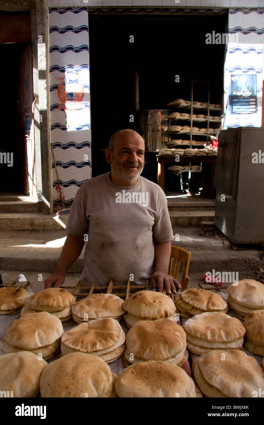 Man selling pita bread at a bakery, Rosetta (Rashid), Beheira, Egypt ...