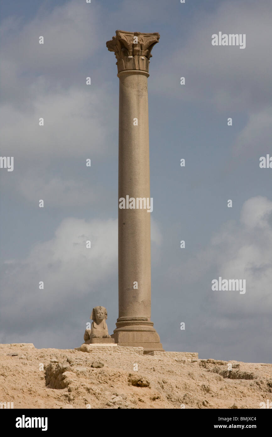 Small sphinx and column of red granite 30m tall Stock Photo - Alamy