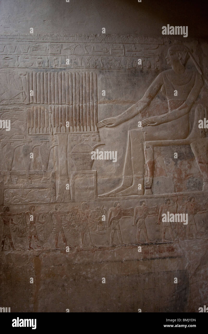 Bas-relief of Mereruka seated in front of an offering table lade with ...