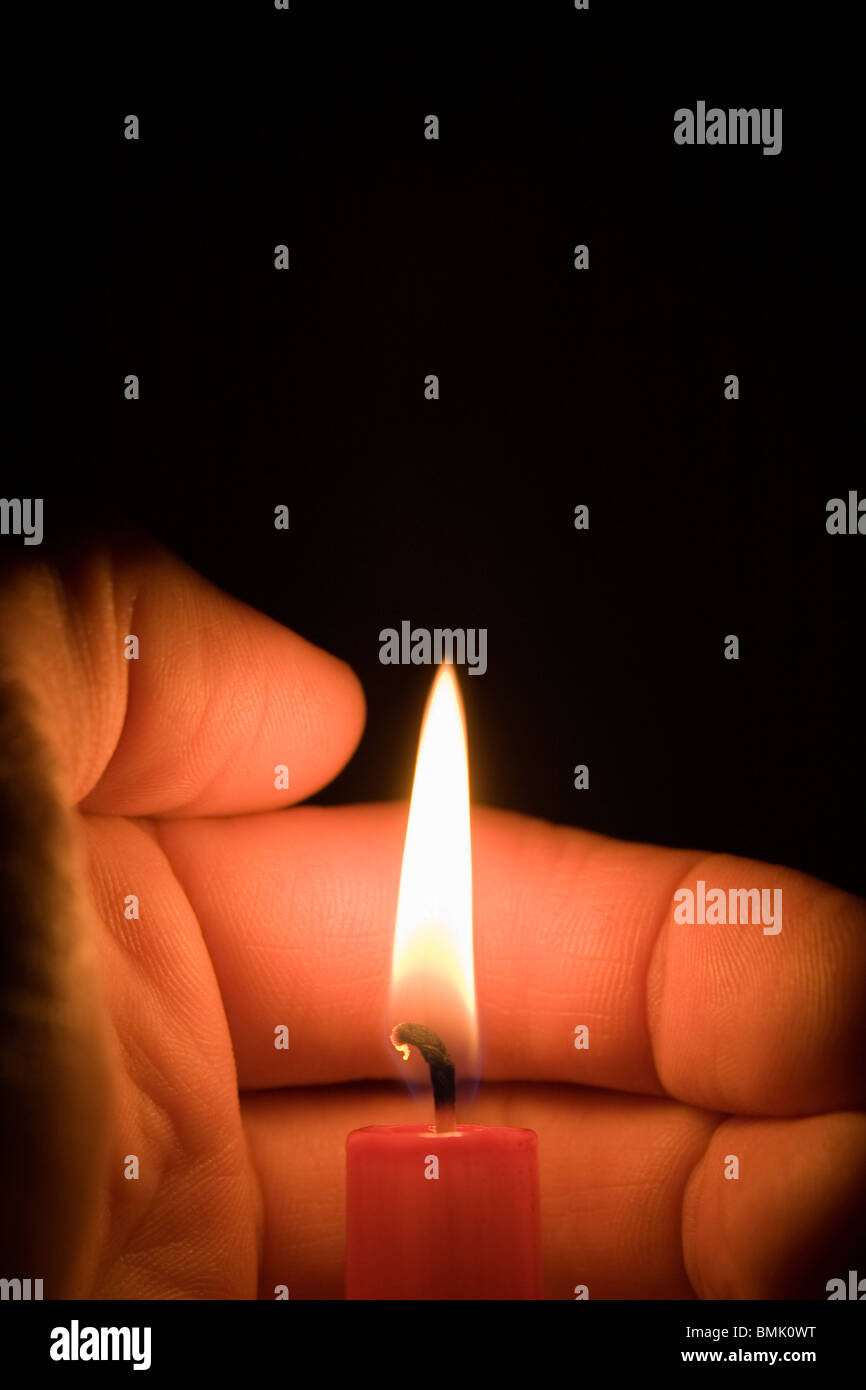 Hand And Candle Stock Photo - Alamy