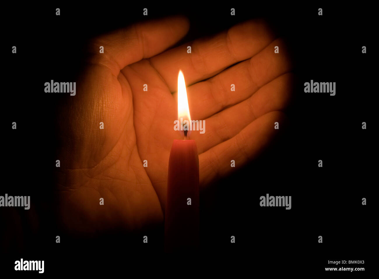 Hand And Candle Stock Photo - Alamy