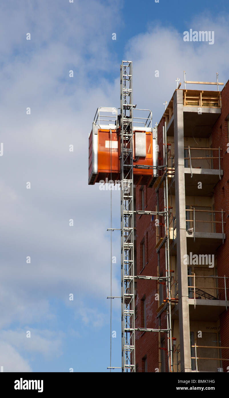 Construction site personnel elevator attached to the building wall ...