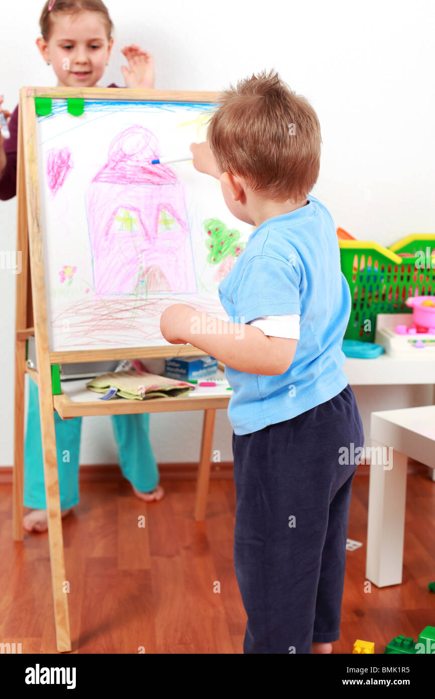 Adorable kids playing with chalkboard Stock Photo - Alamy