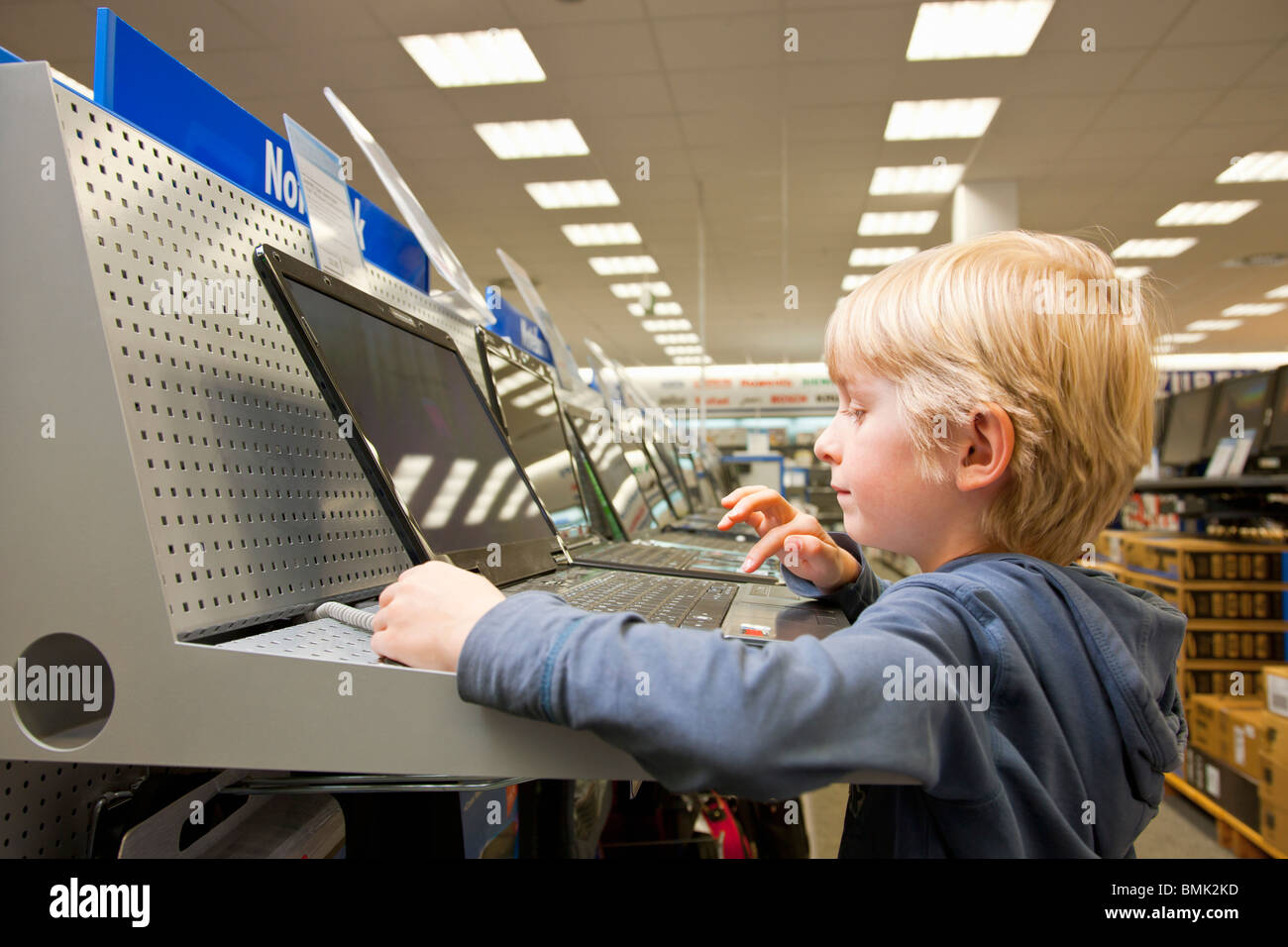 Little boy is testing a laptop computer Stock Photo - Alamy
