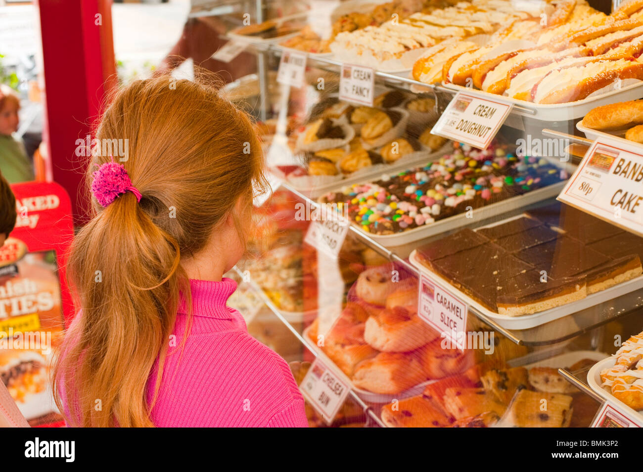 Young girl looking at cakes in Cake Shop. FULLY MODEL RELEASED Stock ...