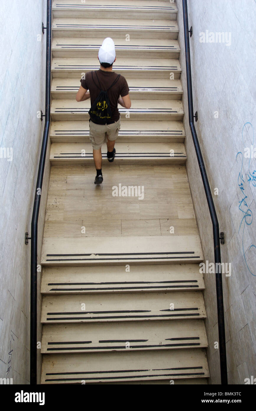Steps hight view, one young man climbing stairs outdoor street scene ...