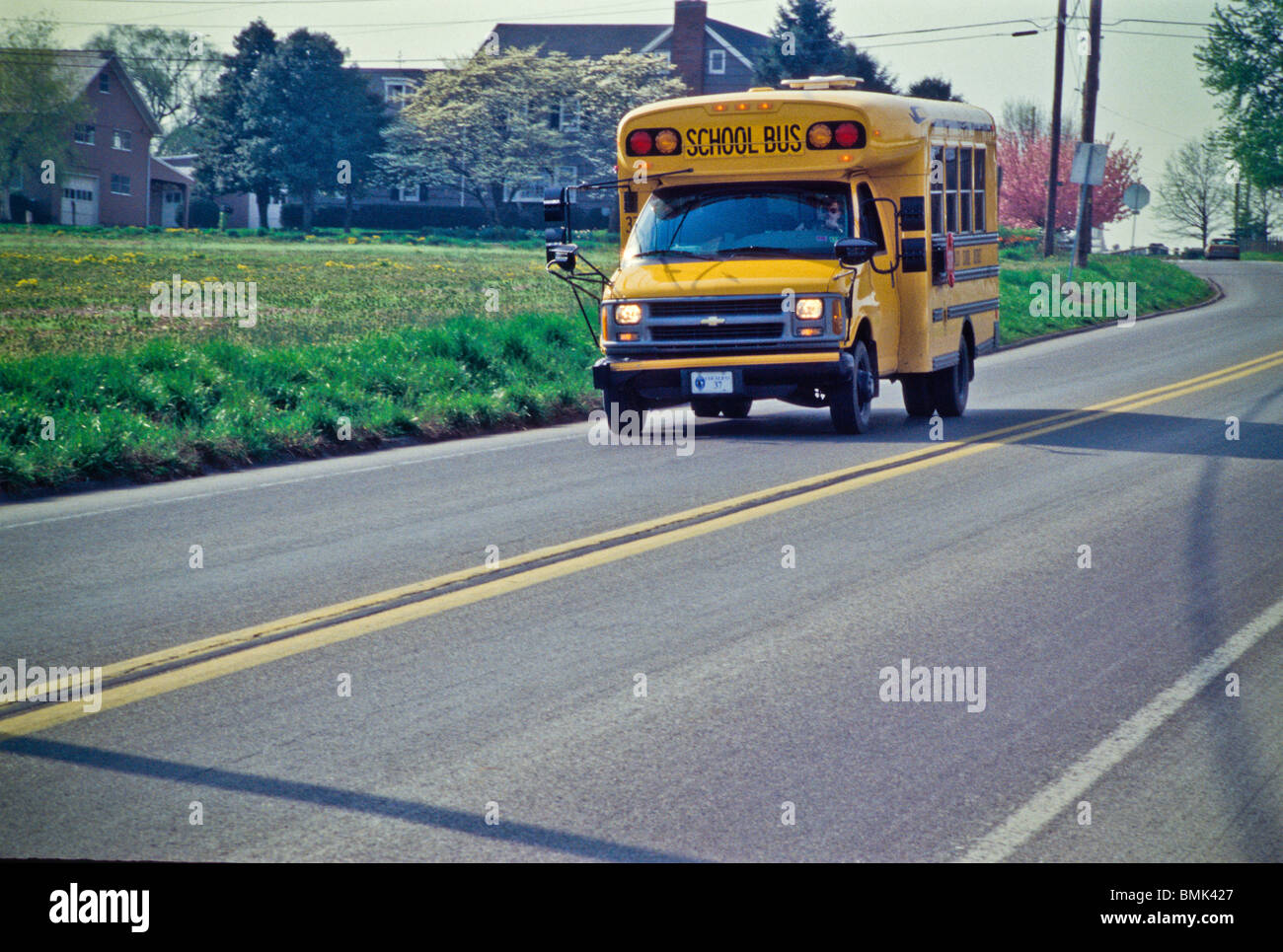 Small yellow school bus transporting students Stock Photo - Alamy