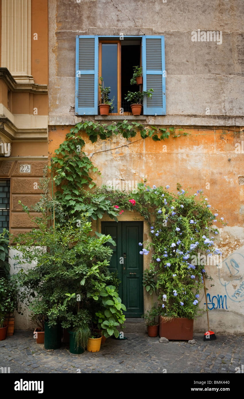 A typical roman house, with flowerpots and traditional walls and ...