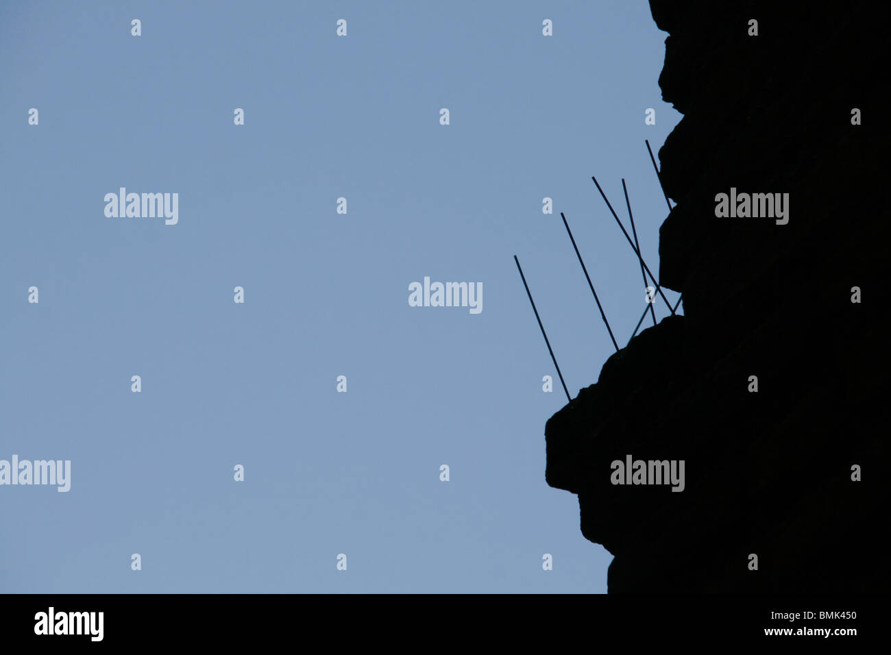 bird repellent metal spikes on monument building wall Stock Photo - Alamy