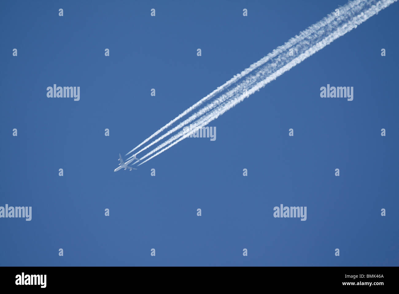 Passenger aircraft with contrails hi-res stock photography and images ...