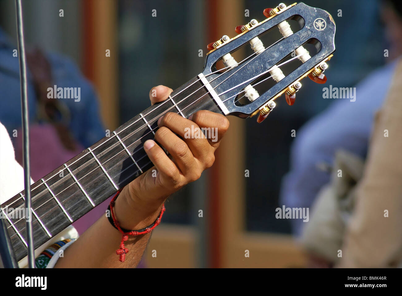 well lit image of man playing six string guitar Stock Photo - Alamy