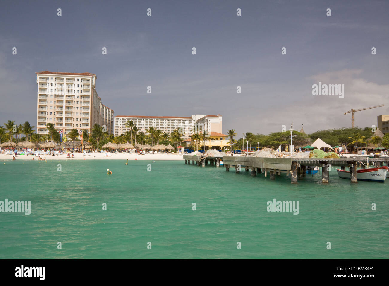 Beautilful calm blue waters with beach, pier and hotels, Aruba ...