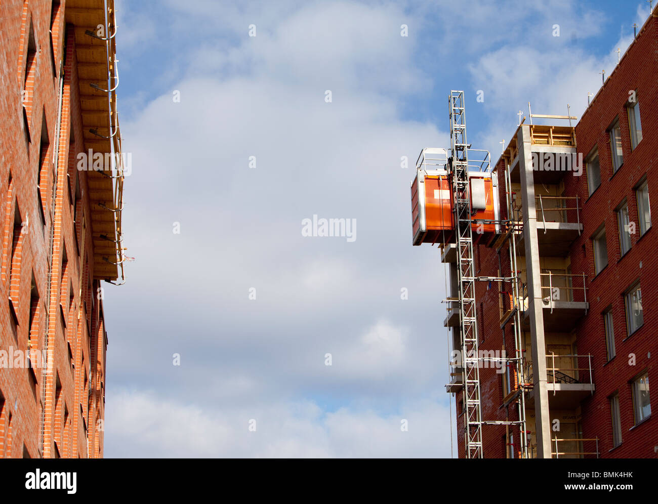 Construction site personnel elevator attached to the building wall ...