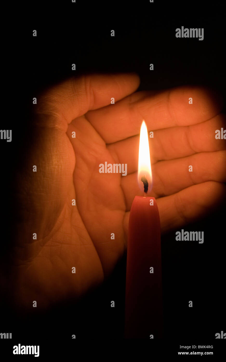 Hand And Candle Stock Photo - Alamy