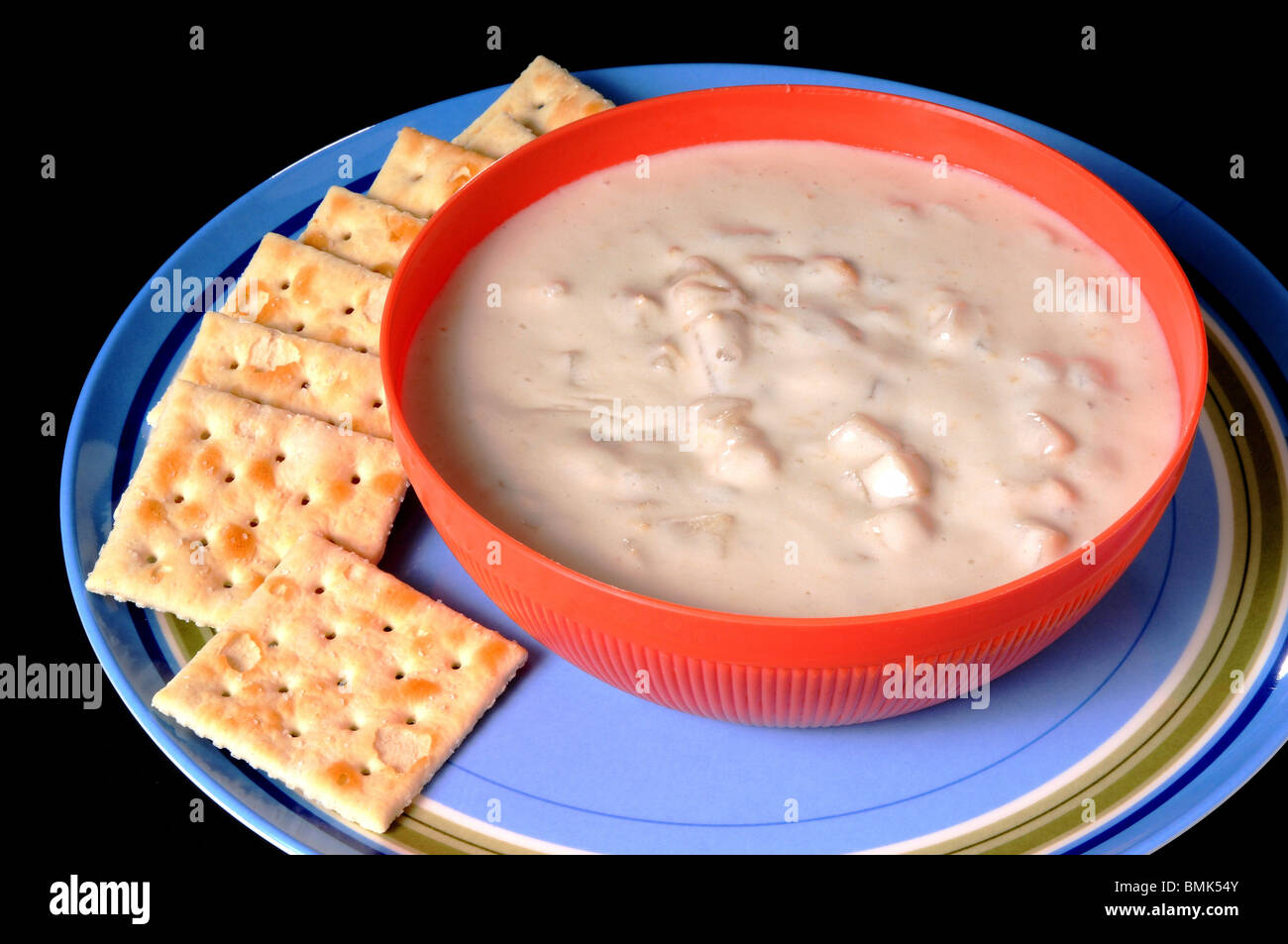 bowl of clam chowder with crackers isolated over black Stock Photo - Alamy