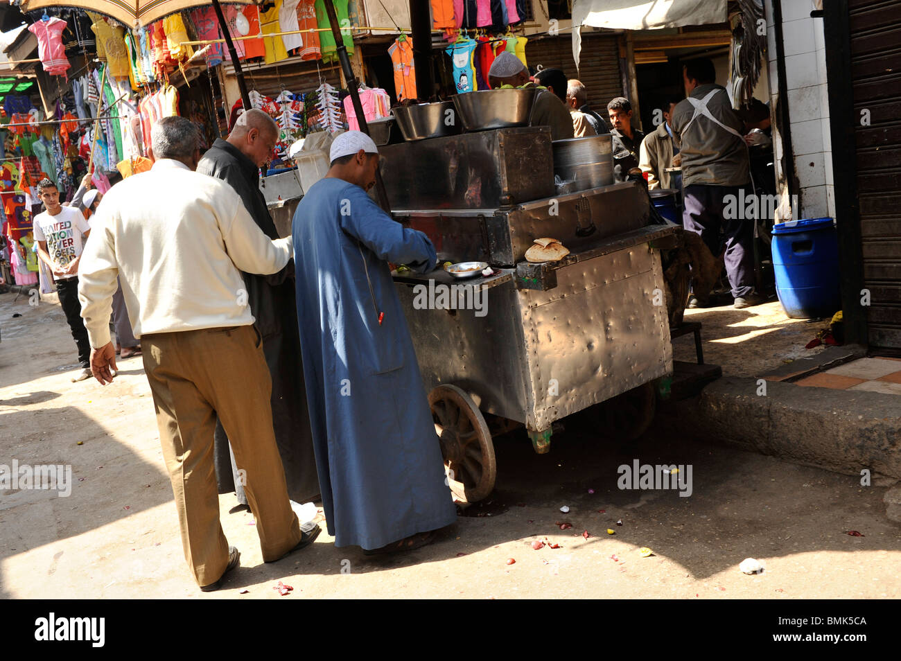 egyptian men having breakfast ( fuul with local traditional bread ...