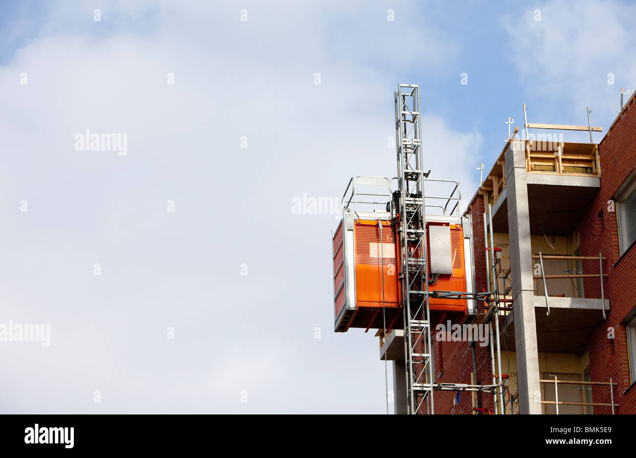 Construction site personnel elevator attached to the building wall ...