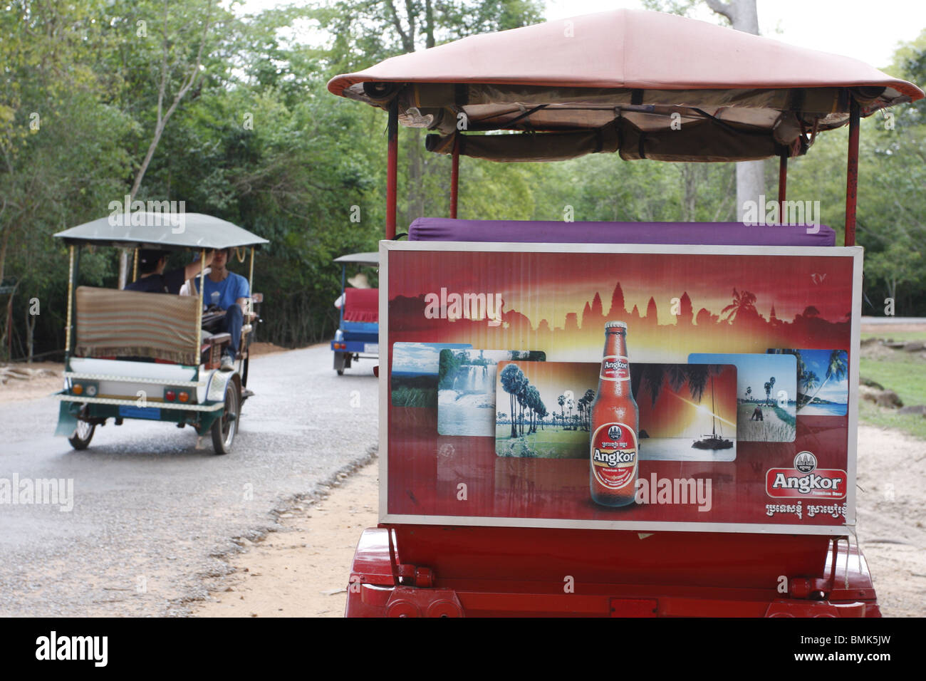 A tuk-tuk (rickshaw) in Angkor Archaelogical Park, Cambodia, with an ...