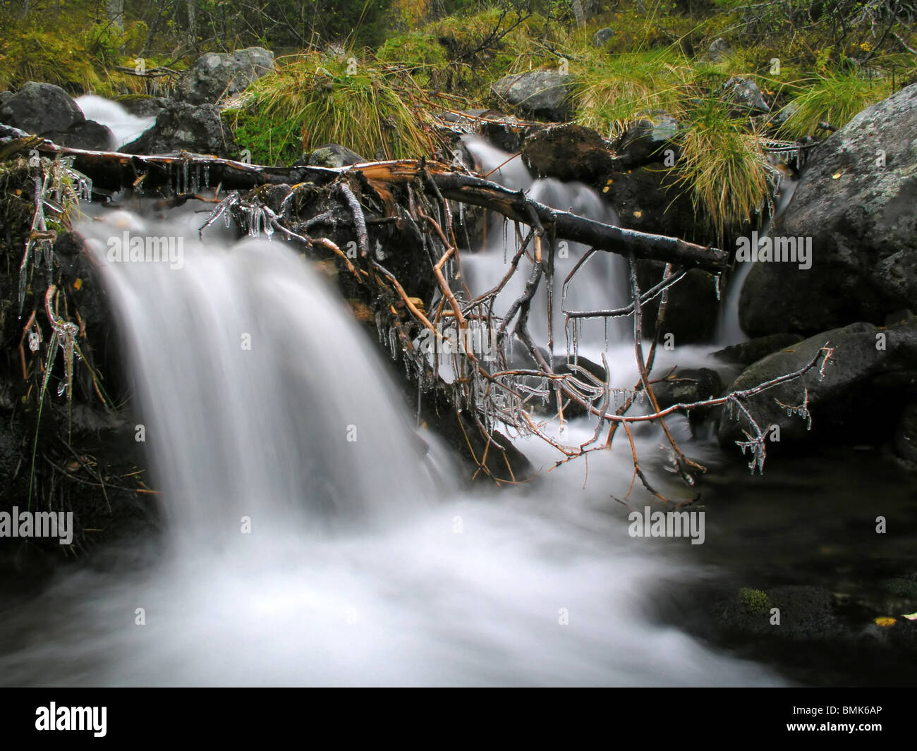 Flowing water from a small waterfall in mountain Stock Photo - Alamy