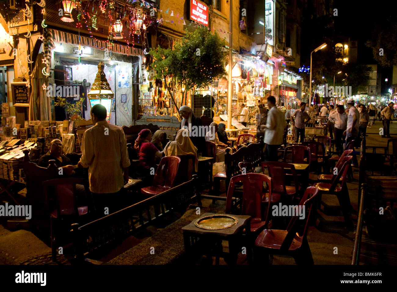 People sitting in outdoor cafes at Khan al-Khalili Bazaar at night ...