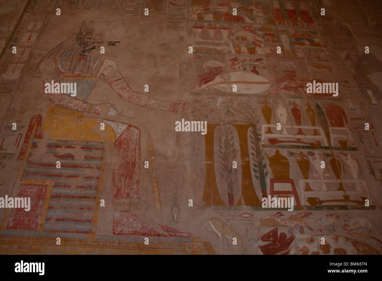 Painting of Anubis enthroned in front of a table with offerings in the ...