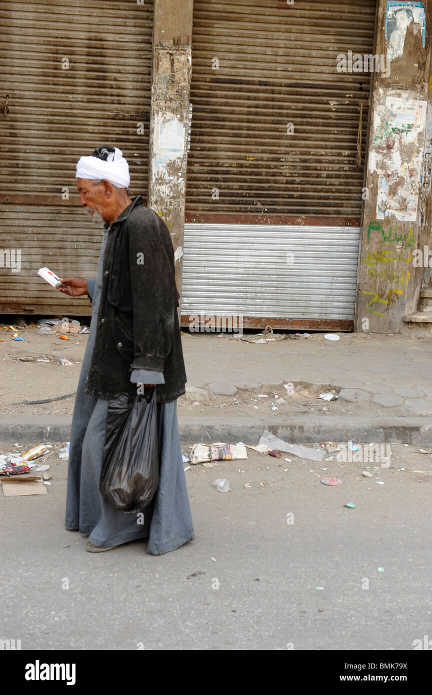 old egyptian man taking early morning walk , islamic cairo , egypt ...