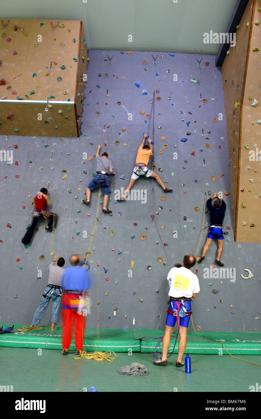 Group of persons on a climbing wall Stock Photo - Alamy