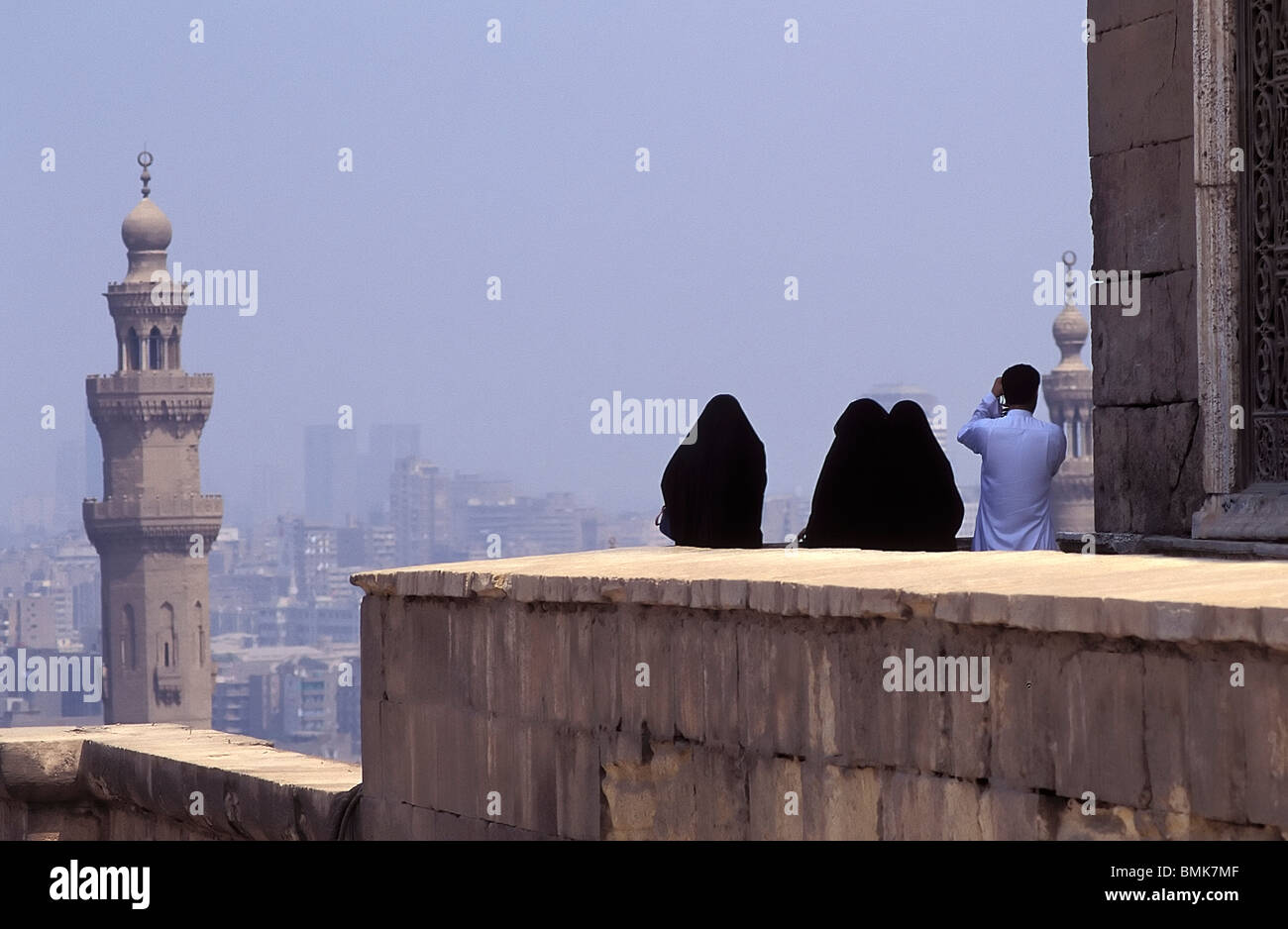 Man and veiled women overlooking Islamic Cairo, Al Qahirah, Egypt Stock ...