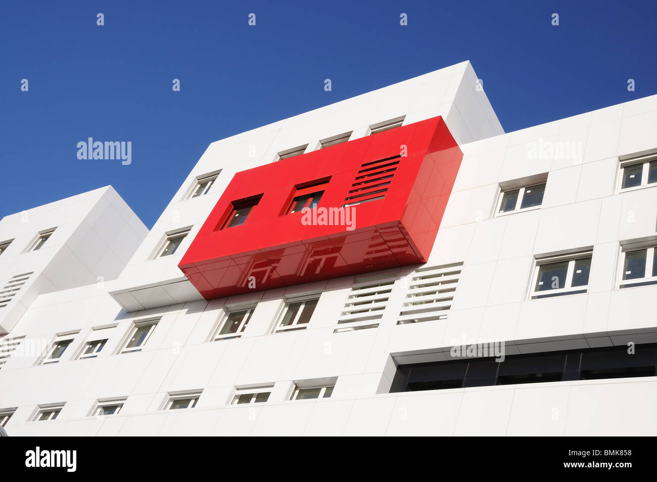 Modern red and white building in the city Stock Photo - Alamy