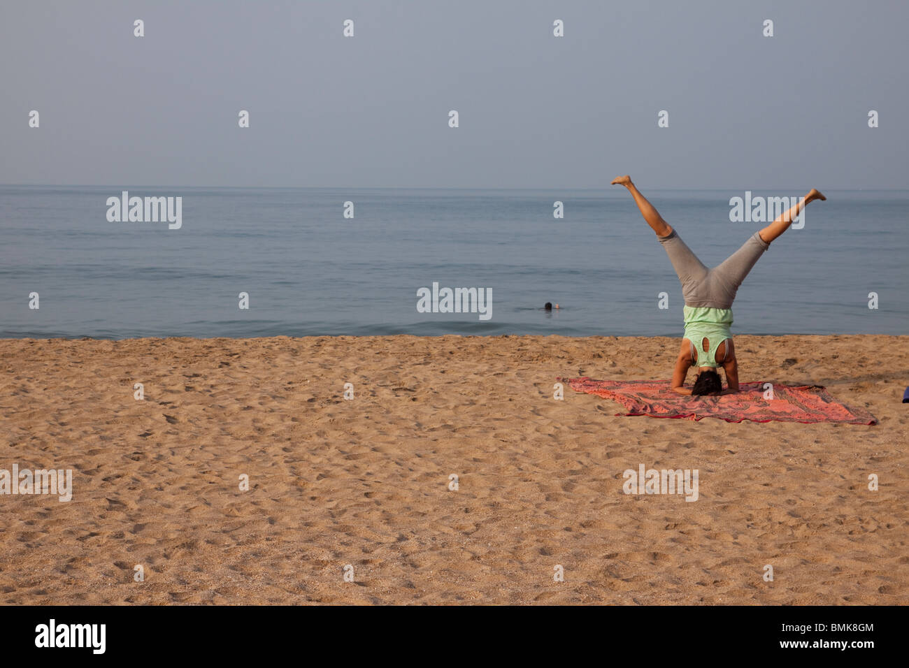 Woman doing headstand on beach hi-res stock photography and images - Alamy
