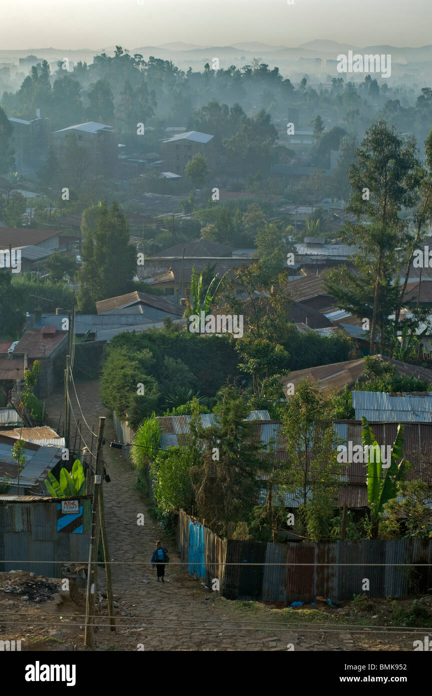 woman walking past corrugated metal fence out of a slum treet scenes ...