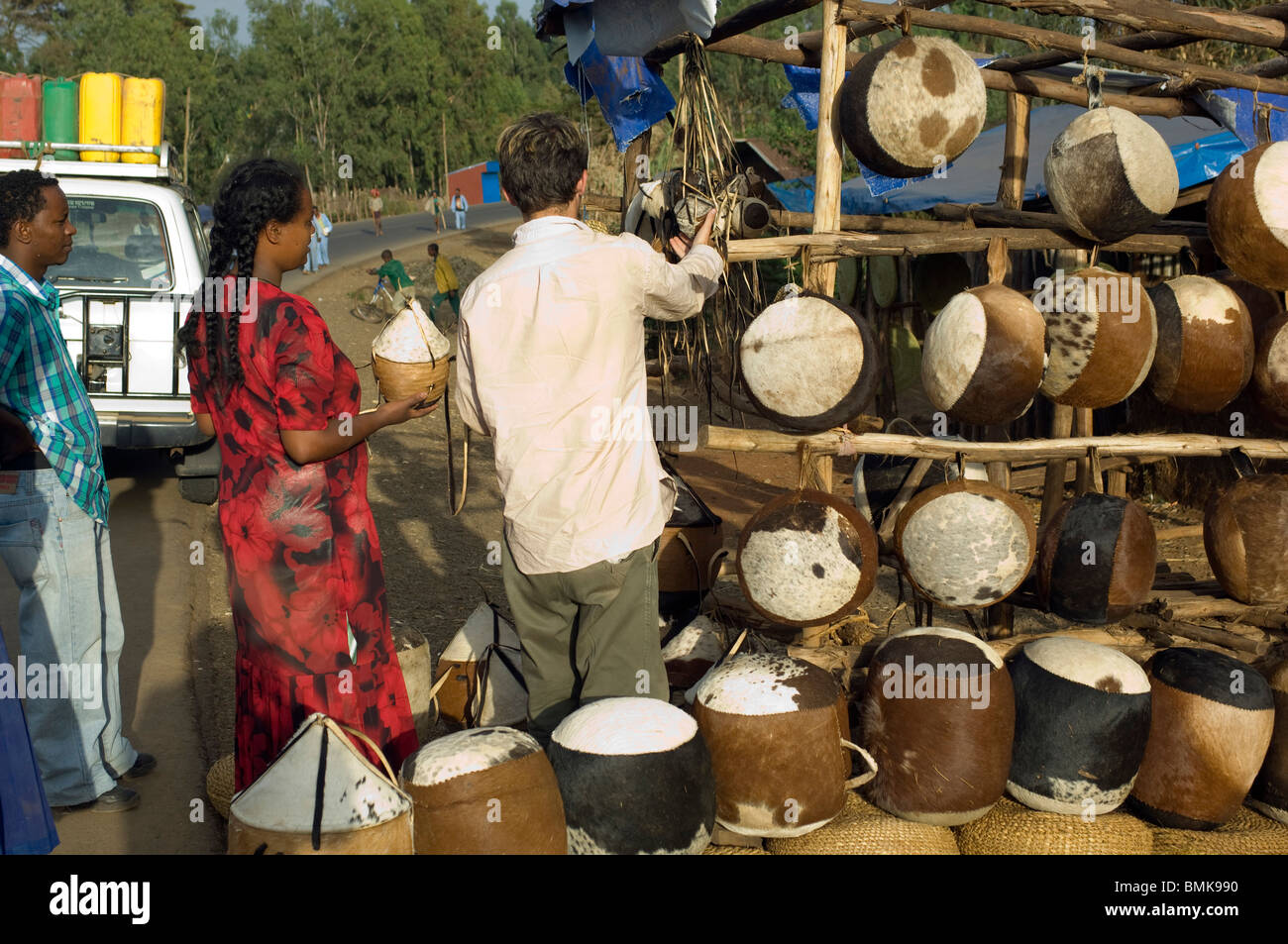 A female vendor helps a tourist buys local lunch boxes from street-side ...