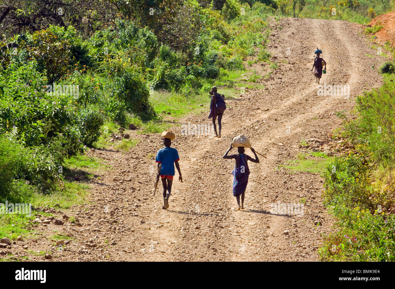 Africa, Ethiopia, Omo region, Kibish. People walking on road between ...