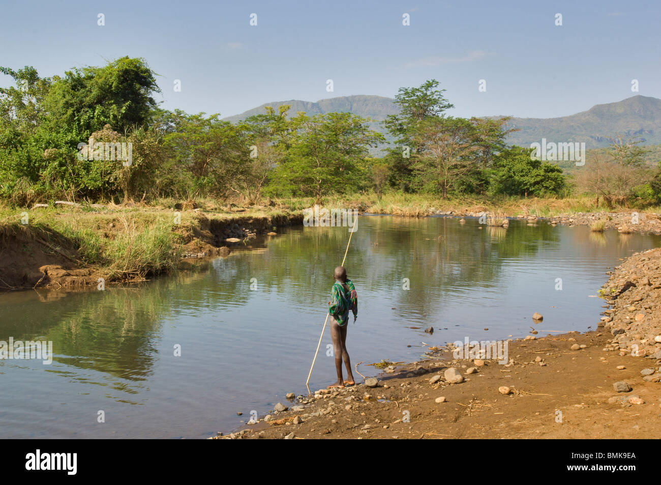 Africa, Ethiopia, Omo region, Kibish. Suri boy crosses river Stock ...