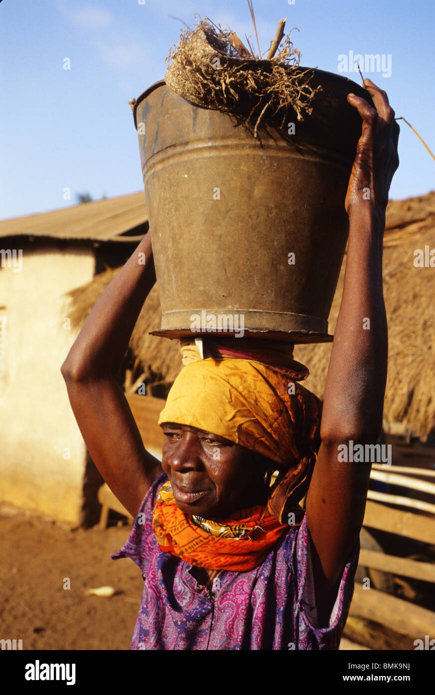 Ghana: Kabile (Borong-Ahafo Region), Ghanaian woman carrying bucket on ...