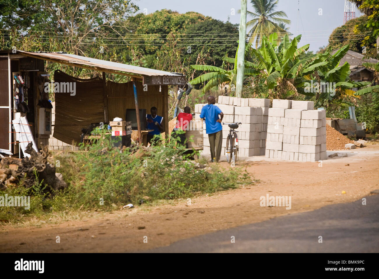 Africa, West Africa, Ghana, Coastal Road. Men at roadside electronics ...