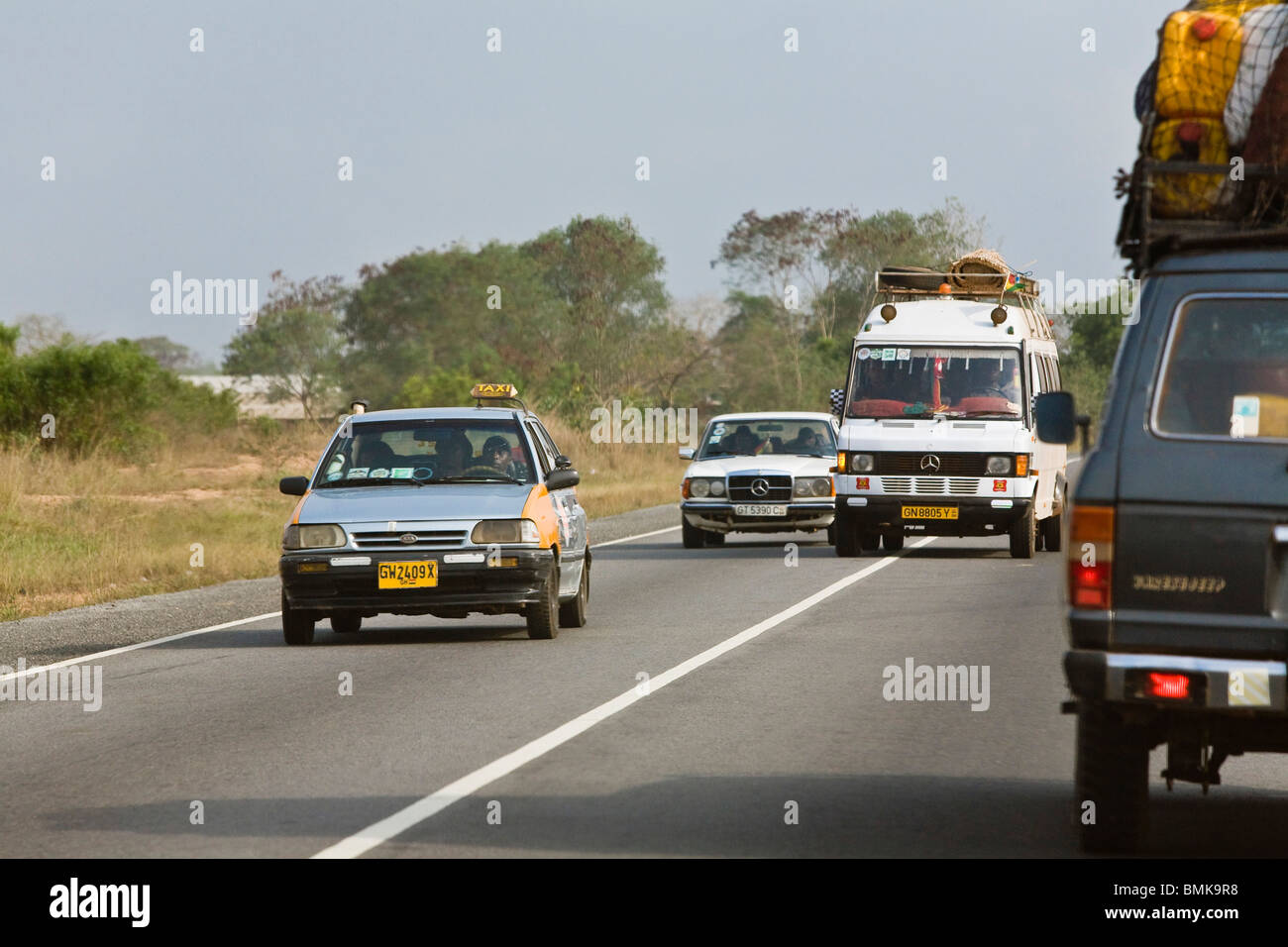 Africa, West Africa, Ghana, Coastal Road. Bus travelling down road ...