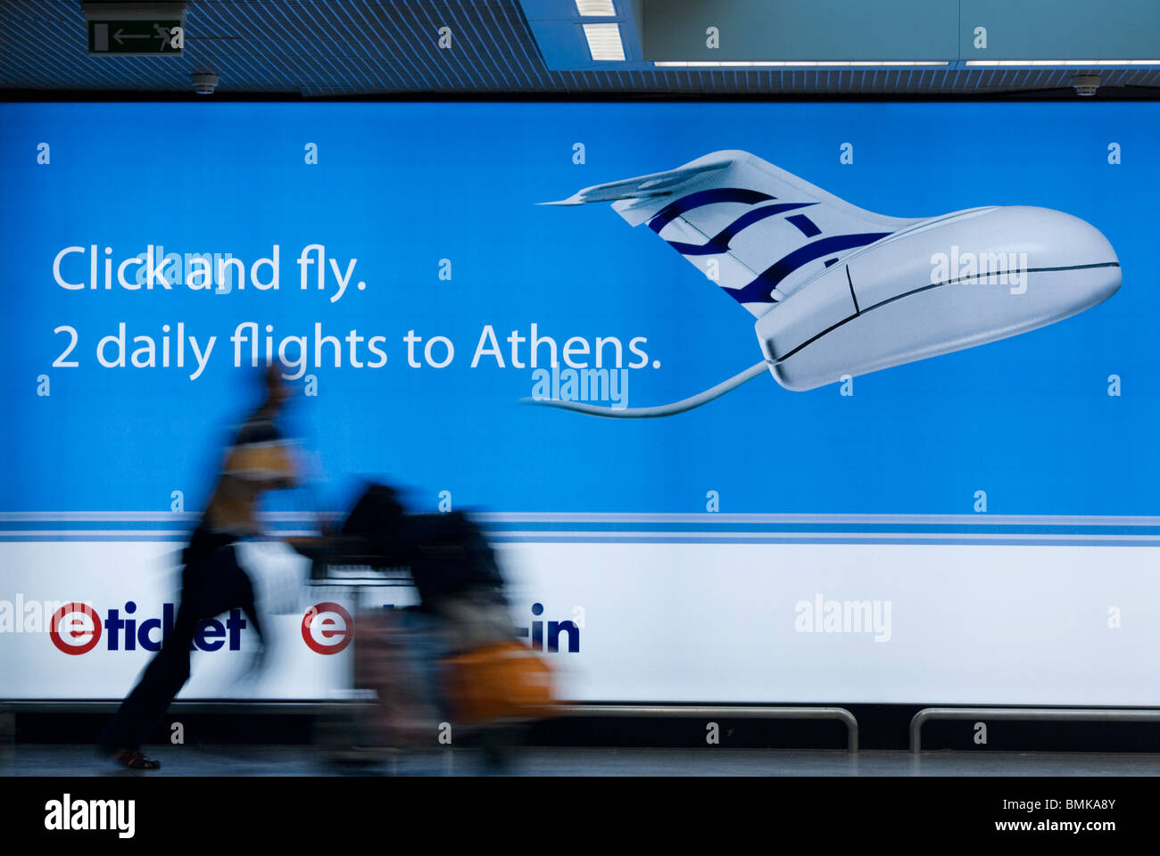 Blurred image of a passenger running to catch a plane with a luggage ...